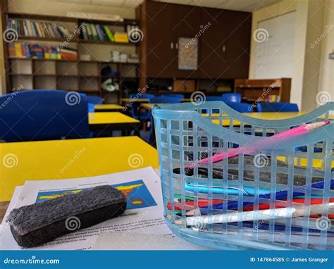 A Close Up Of Messy Teachers Desk In A Classroom Stock Image Image Of