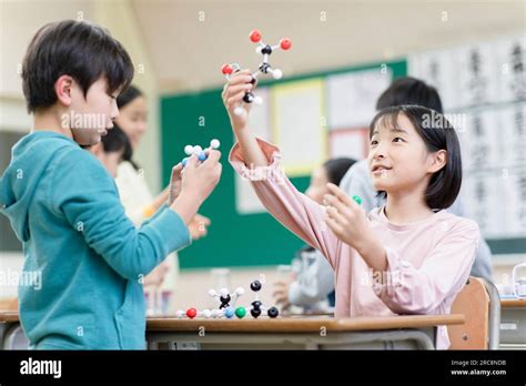 Elementary School Students Assembling A Model In The Classroom Stock