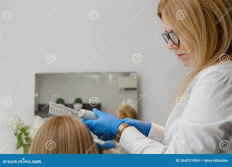 Doctor Making Hair Treatment Using Darsonval Apparatus At Trichologist