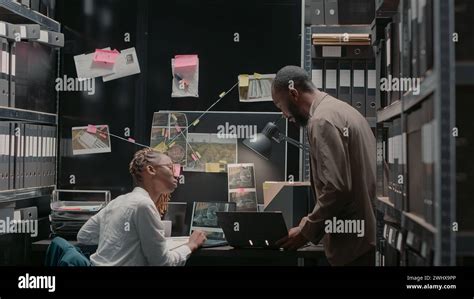 Private Detectives Checking Crime Scene Photos On Map Working To Find