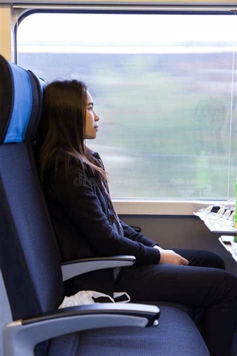 Cute Young Asian Female Tourists Sitting On The Express Train Stock