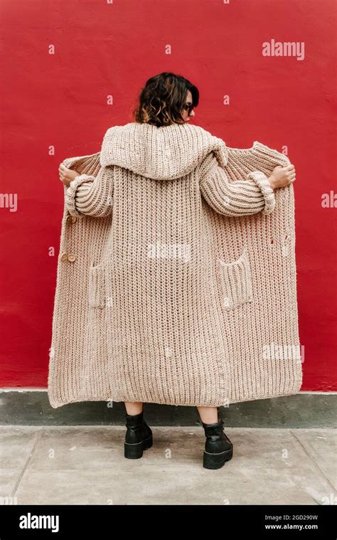 Vertical Image Of A Woman With An Open Sweater With Her Body Facing The
