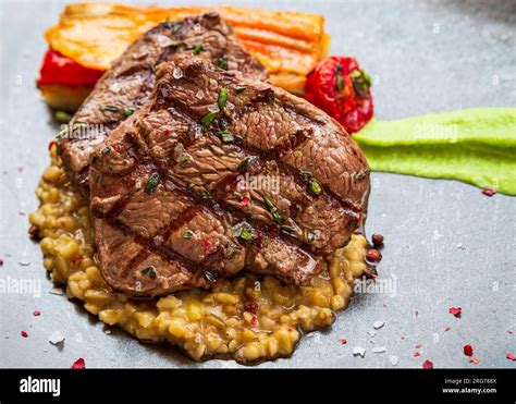 Grilled Beef Steak And Risotto Beef Steak With Vegetables On A Plate