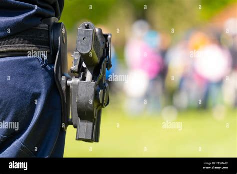 Police Automatic Pistol On The Side Of A Police Officer In Blue Uniform
