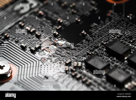 Black Printed Circuit Board With Microchips And Capacitors Macro Photo