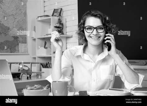 Female Teacher With Mobile Phone In The Classroom On The Chalkboard College Girl In Class Stock