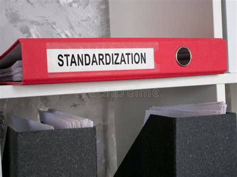 A Folder With Documents About Standardization On A Shelf Stock Image