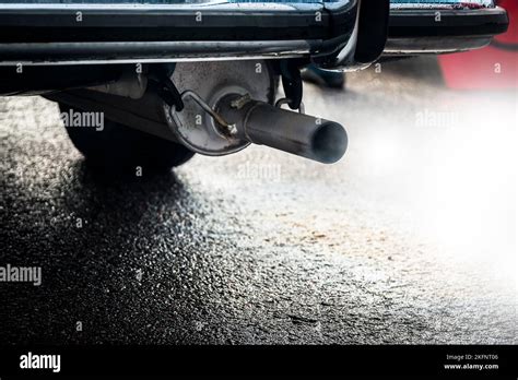 combustion fumes coming out of car exhaust pipe, exhaust gas from a car with diesel or gasoline ...