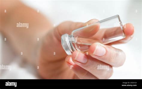 Closeup Photo Of Nurse Holding Glass Ampule With Medication Closeup