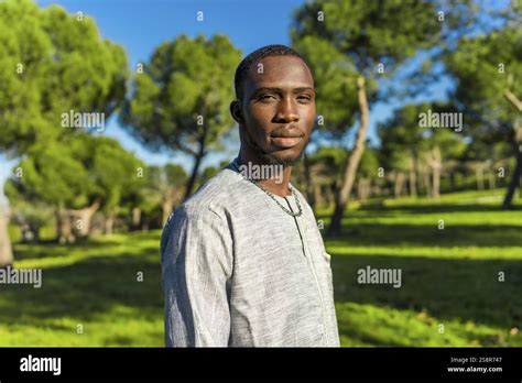 Portrait Of A Young African Man From Senegal Wearing Traditional Clothing In A Park