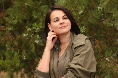 Cute Beautiful Dark Haired Girl In A Green Jacket In The Summer