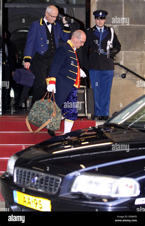 Servants Of The Queen Carry Bags Of The Queen At The Royal Palace In