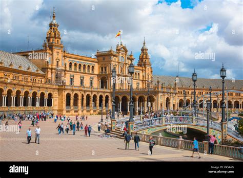 Plaza De Espana Seville View Of People Walking Through The Historic