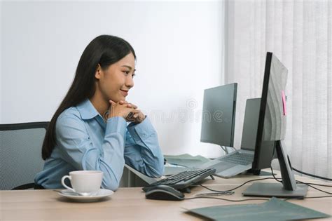 Asian Woman Software Developers Sitting In Front Of Computers Looking
