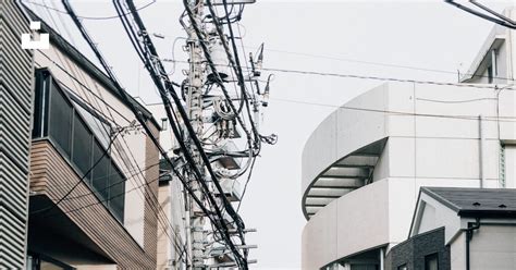 Narrow Street Lined With Buildings And Overhead Wires Photo Free