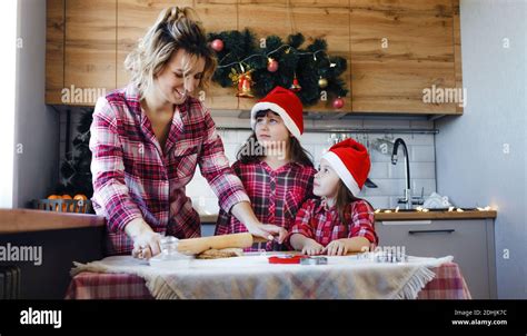 Mom Teaches Her Daughters In The Kitchen To Make A Delicious Dessert