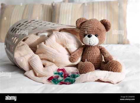 Laundry Detergent Capsules Teddy Bear And Basket With Clean Linens On