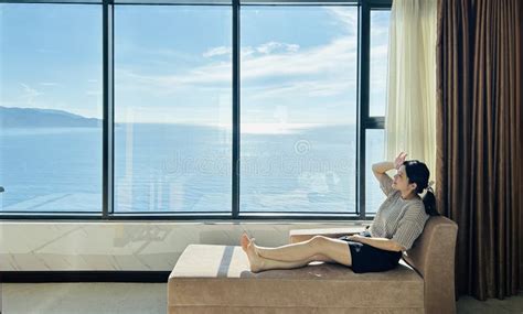 The Girl Is Lying On The Bed Enjoying The Sunlight And The Great View Of The Sea Level Stock