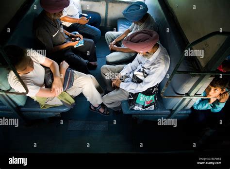 Western European Passenger Sitting With Local Passengers In A Sleeper