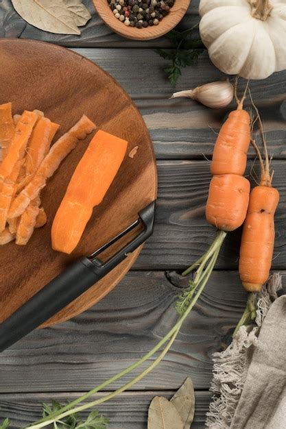 Premium Photo Peeling Ripe Carrot With Vegetable Peeler Flat Lay View
