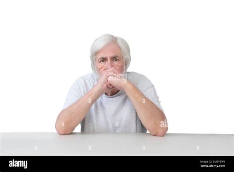 Horizontal Shot Of A Worried White Haired Old Man Seated With His
