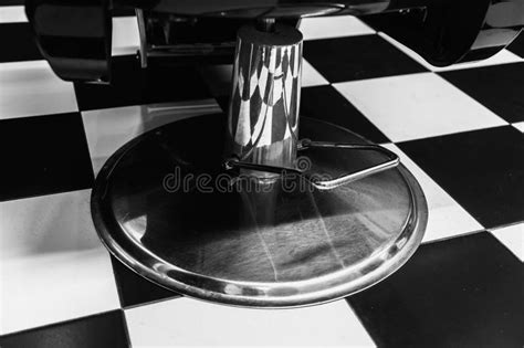 Reflections On A Shiny Bar Stool And Contrasting Checkered Floor Stock
