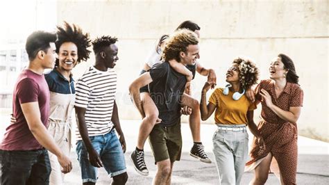 Multiracial Young People Having Fun Together Walking On City Street