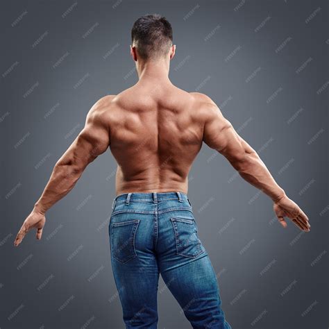 Premium Photo Male Bodybuilder Flexing His Back Muscles On Grey