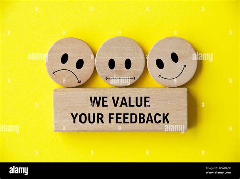 We Value Your Feedback Text On Wooden Block With Happy Sad And Neutral