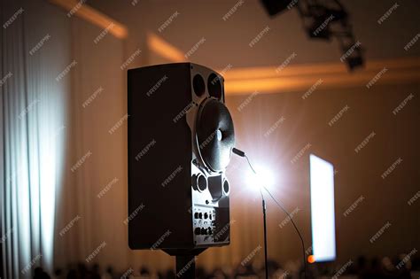Premium Photo Audio Speaker On Stage At Conference Stands In Bright