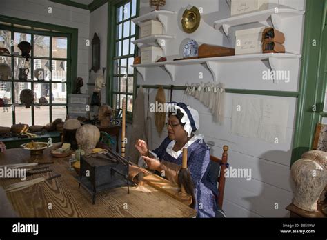 A Woman Makes A Wig In The Barber And Peruke Maker Shop At Colonial Williamsburg Virginia Stock
