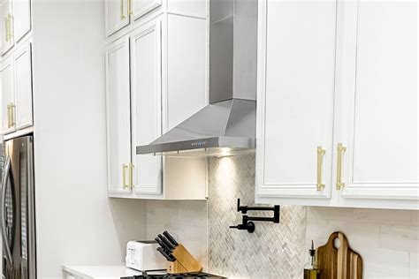 Wall Mount Angled Stainless Steel Range Hood Between White Decorative