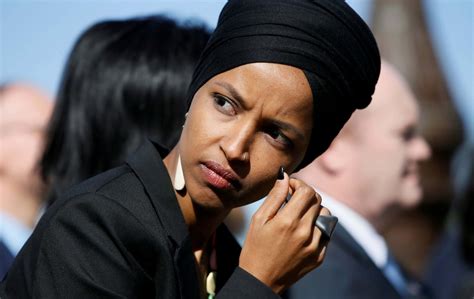 Ilhan Omar Portrait In Black Hijab Focused Expression Wallpaper