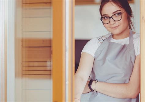 Premium Photo Young Woman Standing Near Desk In The Kitchen