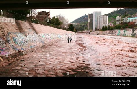 Dolly In Tracking A Young Couple Passing Under A Bridge From Dark To