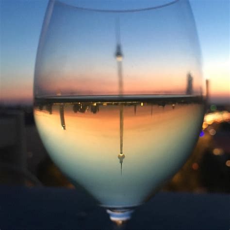 Reflection Of Tower In Wineglass Premium Photo