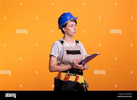 Construction Worker Taking Notes And Measurements To Work On Renovating