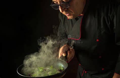 Cooking Fresh Vegetables In The Kitchen The Chef Is Holding A Hot Pan