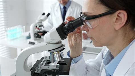 A Female Scientist Using Microscope In Laboratory Generative Ai Stock