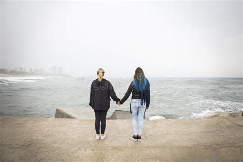 Couple Of Two Unrecognizable Young Woman Holding Hands Friendship