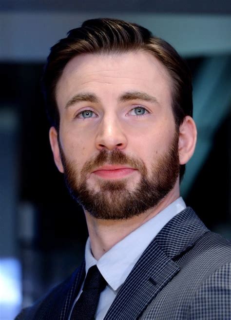 A Close Up Of A Person Wearing A Suit And Tie