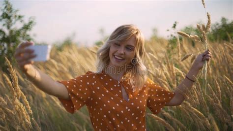 Attractive Fun Hippie Blonde Woman In The Field At Sunset Making A