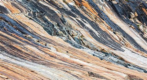 Colourful Geologic Striations And Patterns On Rock Formation At Bottom