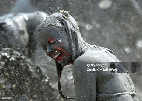 A Tourist Plays In The Mud During The 13th Boryeong Mud Festival At