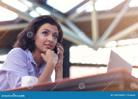 Portrait Of Young Girl Talking On Phone While Drinking Coffee Stock