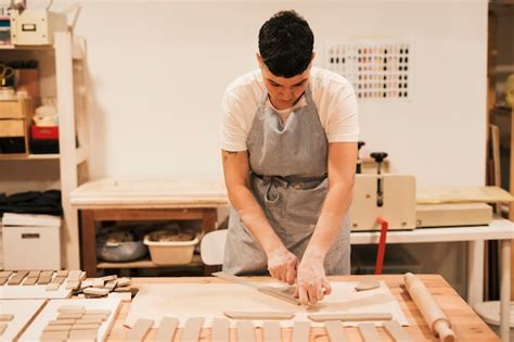 Free Photo Female Potter Cutting The Clay In Rectangular Shape