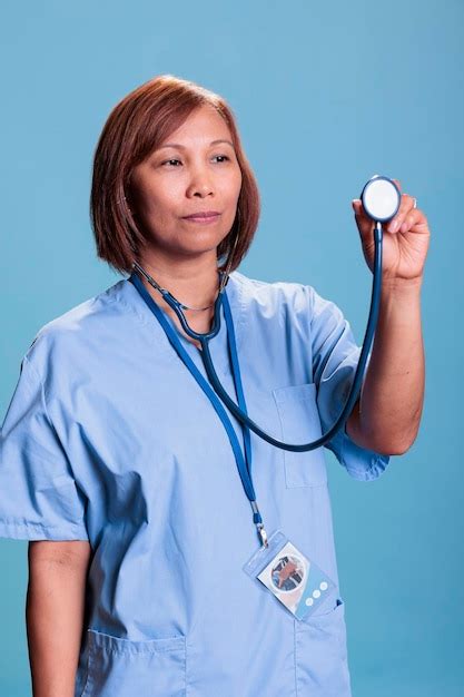 Premium Photo Senior Asian Specialist Nurse In Blue Uniform Holding