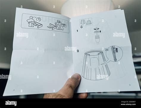 Paris France Oct 25 2023 Hand Holding An Ikea Assembly Manual Page