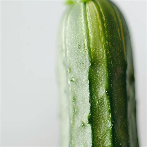 A Bottle Of Cucumber Has Water On It Premium Ai Generated Image