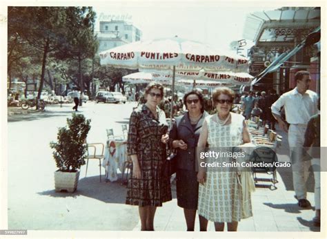 Italian Tourists Three Mature Women Standing Near A Cafe On An